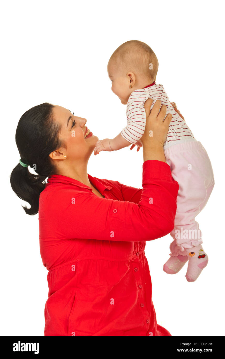 Happy mother raising her arms and holding her baby girl isolated on ...