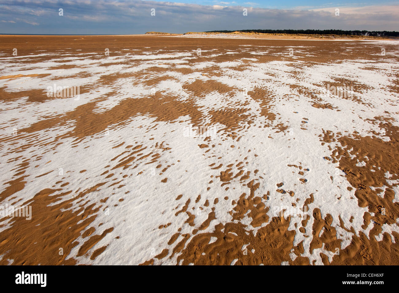 Snow covering the sand dunes and beach at Holkham bay on the Norfolk ...