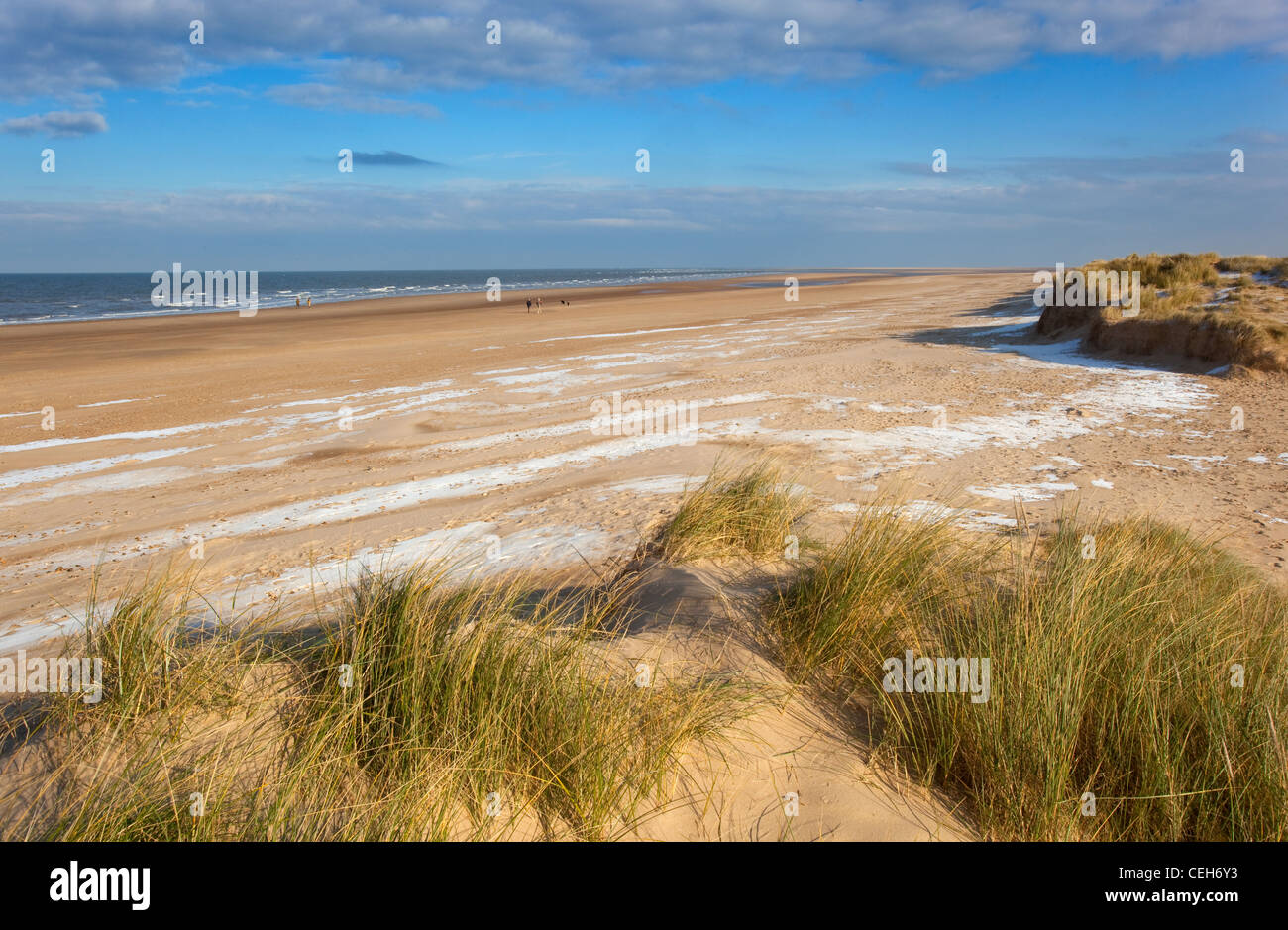 Snow covering the sand dunes and beach at Holkham bay on the Norfolk ...