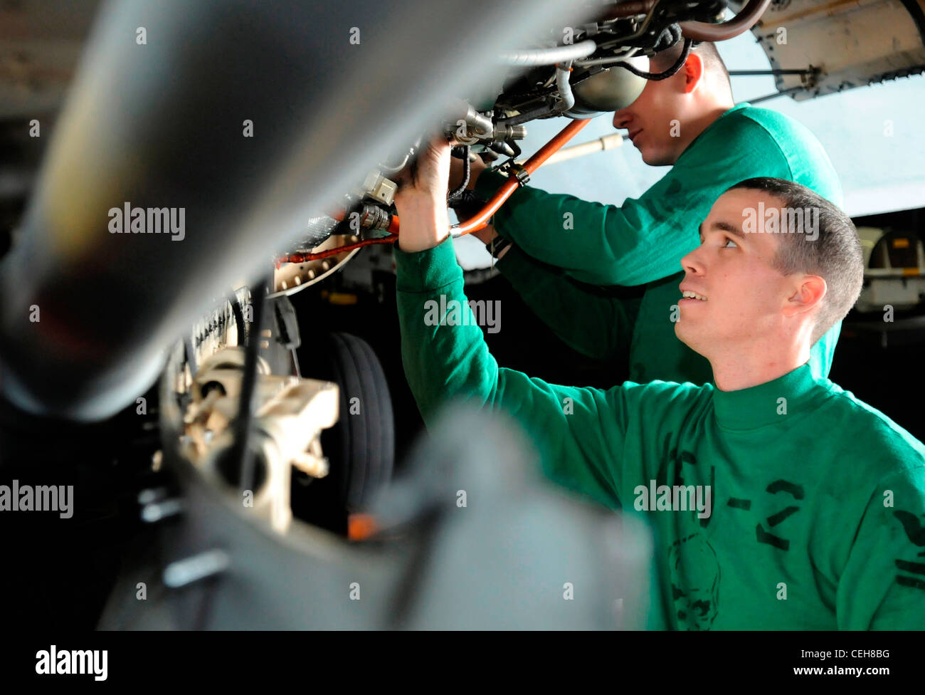 Aviation Machinist's Mate 2nd Class Ryan Caceres inspects an engine ...