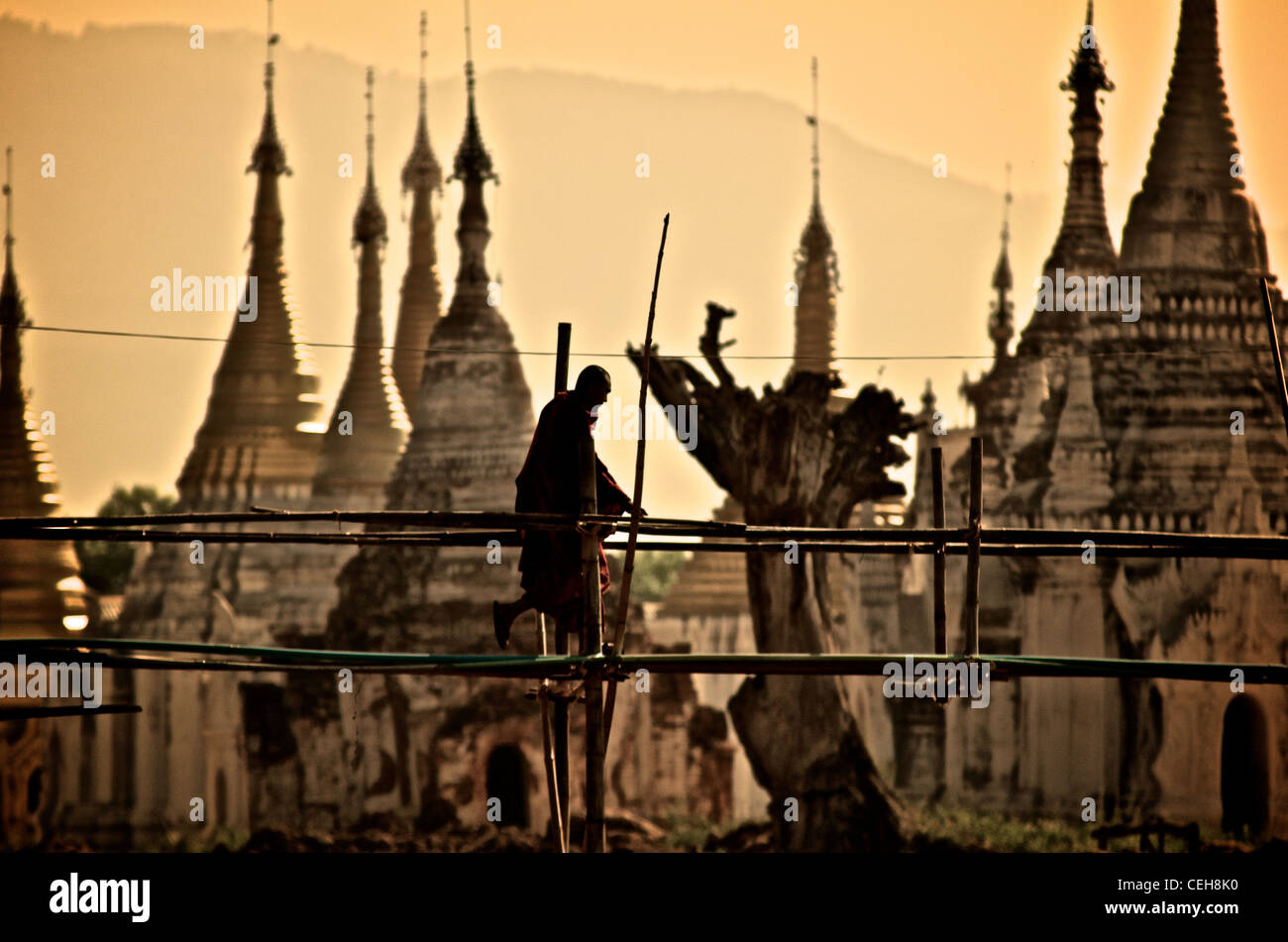 Monk crossing a bridge Stock Photo - Alamy