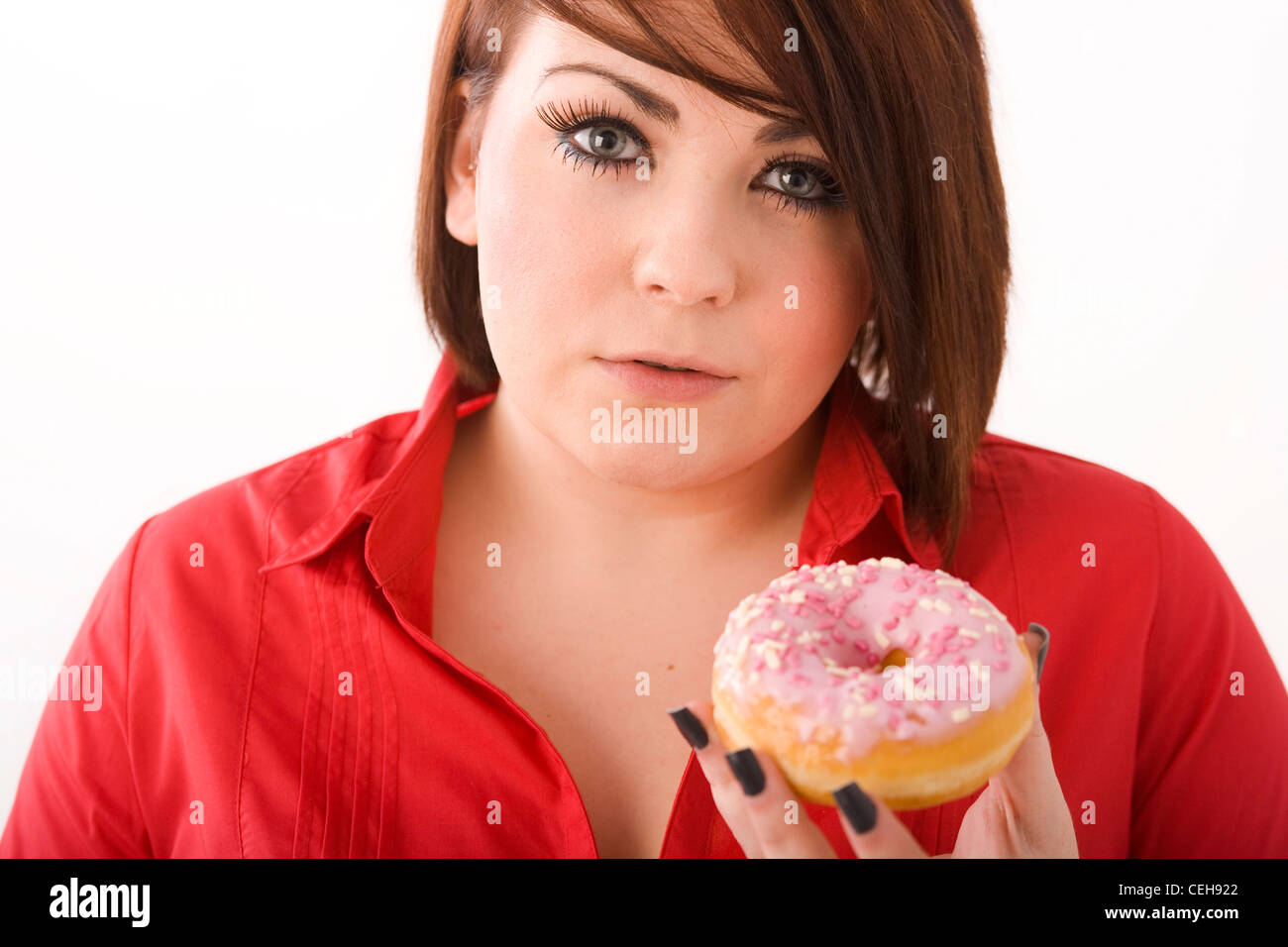 woman holding a single iced donut Stock Photo - Alamy