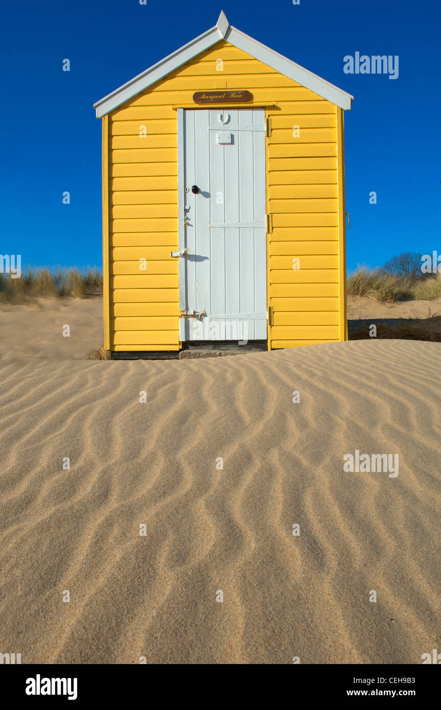 The old traditional beach huts amongst the sand dunes at Southwold in ...