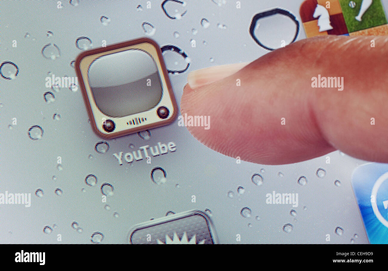 A finger pointing at the youtube app on an Apple ipad2 Stock Photo - Alamy
