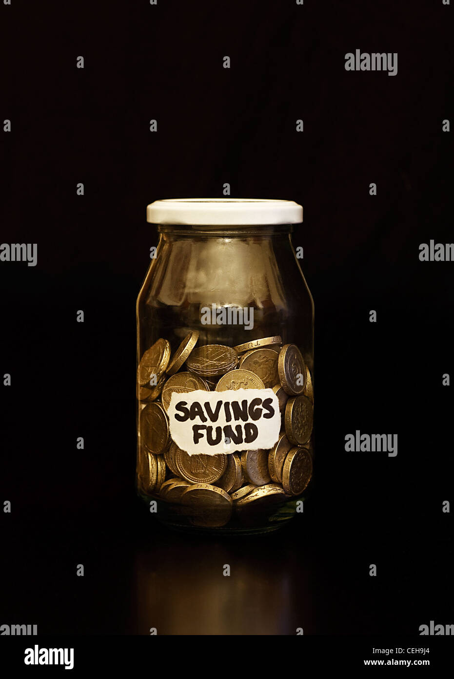 savings money jar containing British Pound Coins Stock Photo - Alamy
