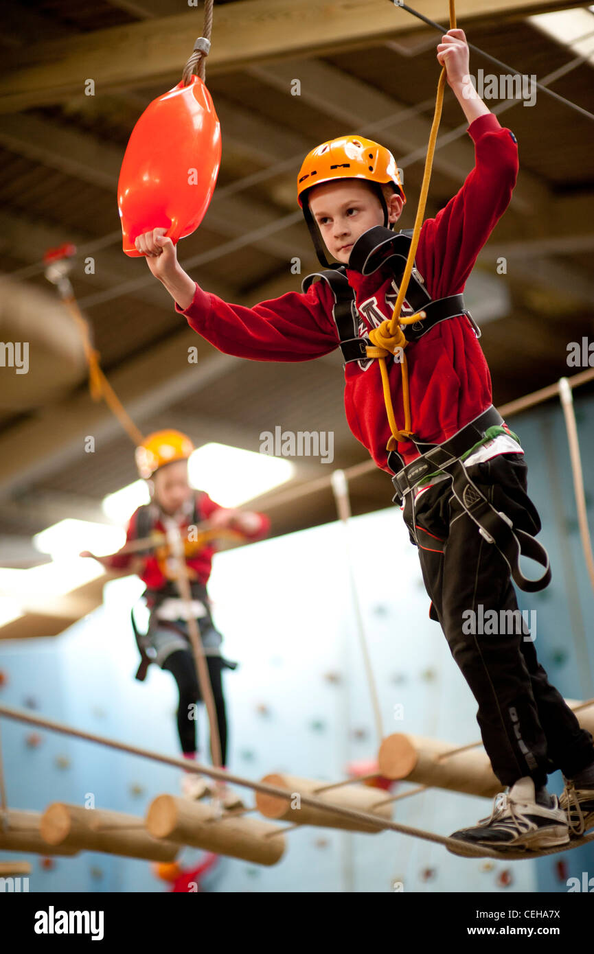 Children using the high rope facilities at an all-weather indoor ...