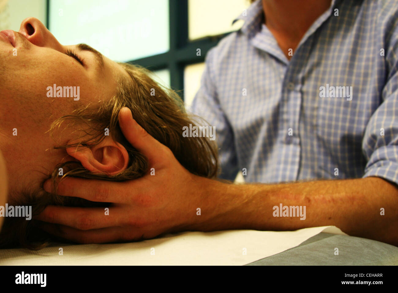 Healer feeling a patient's head Stock Photo - Alamy