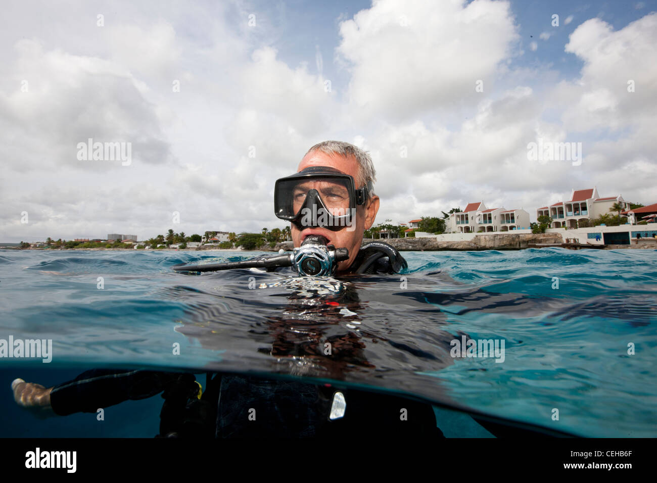 Scuba diver at water's surface Stock Photo - Alamy