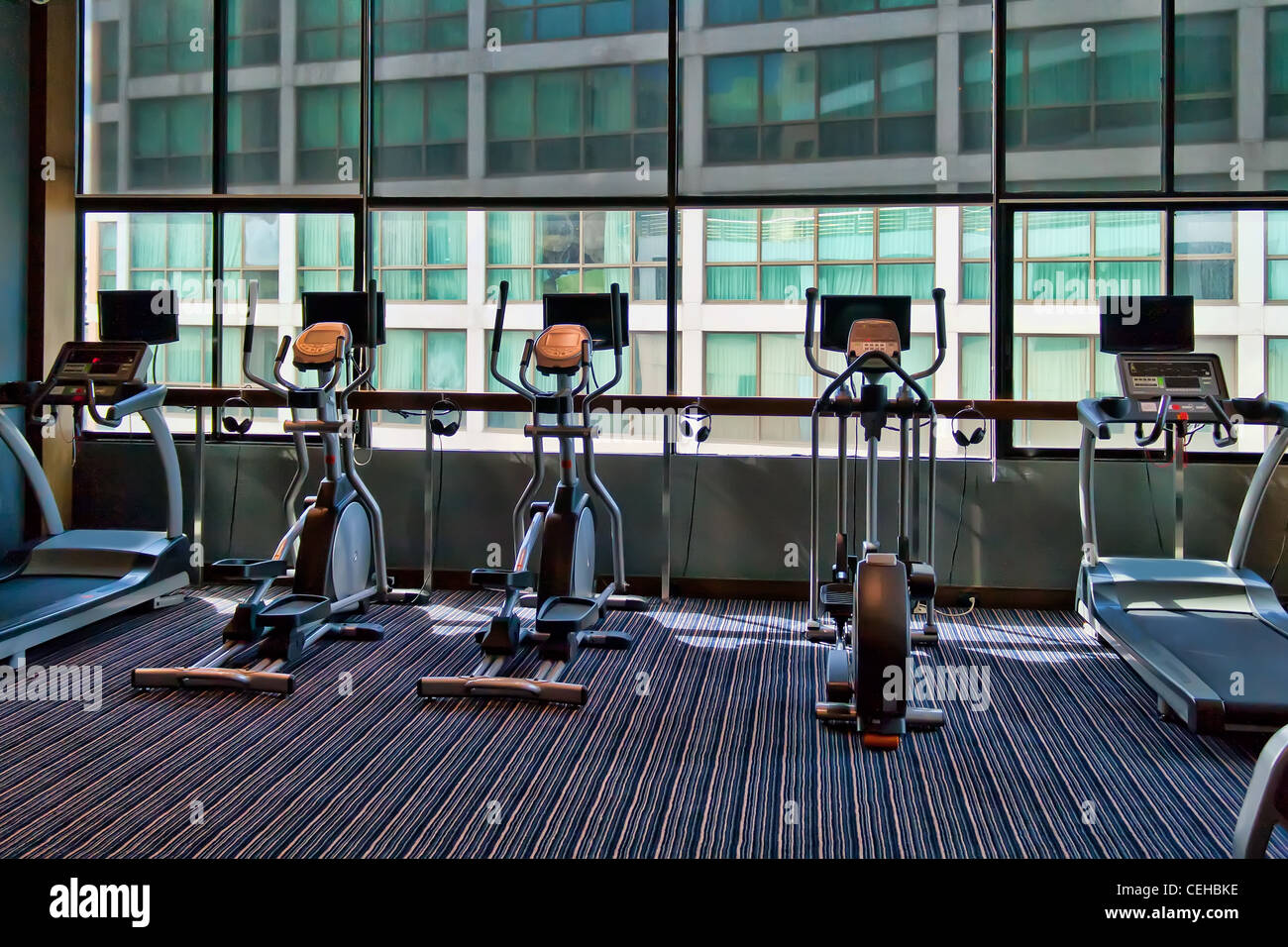 gym with large windows and a stationary bike Stock Photo - Alamy