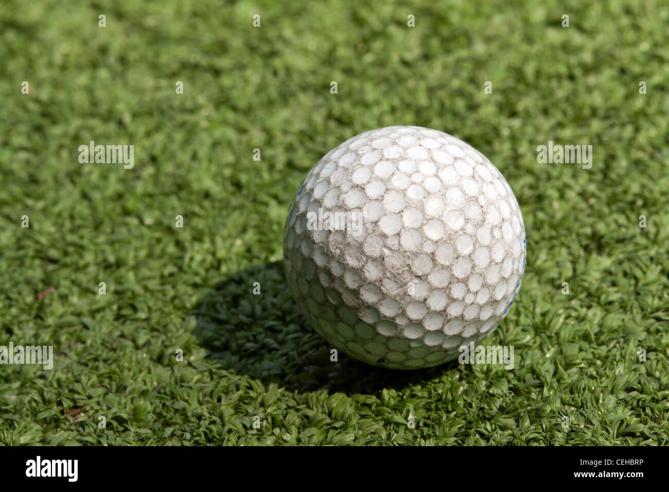 old scratched dirty golf ball on artificial turf Stock Photo - Alamy