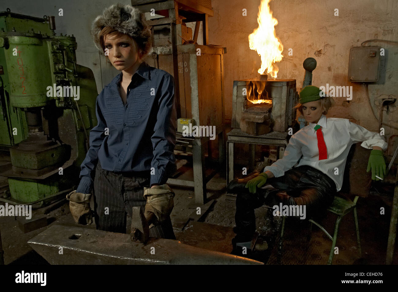 Stylish working women in old factory Stock Photo - Alamy