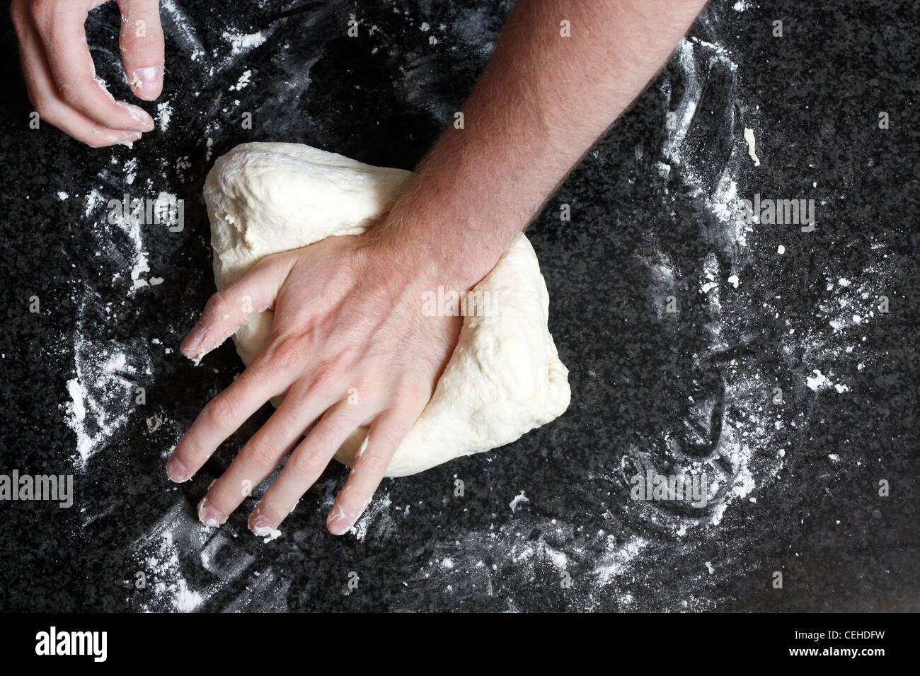 Hands kneading a dough Stock Photo - Alamy