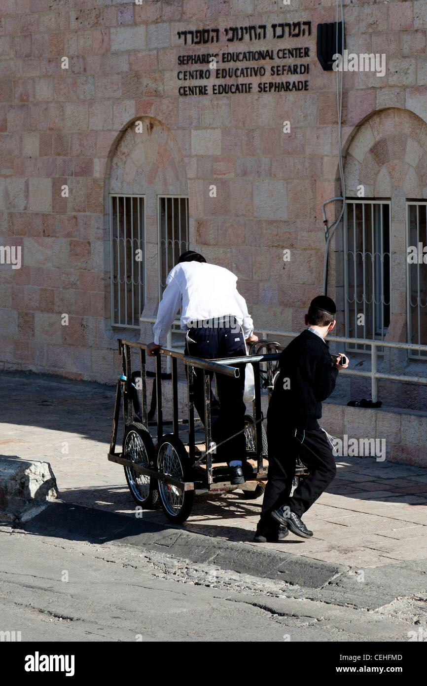 Two Jewish boys play with a delivery cart in the Old City in Jerusalem ...