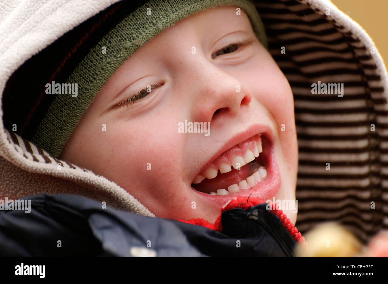 A young boy looking and smiling Stock Photo - Alamy