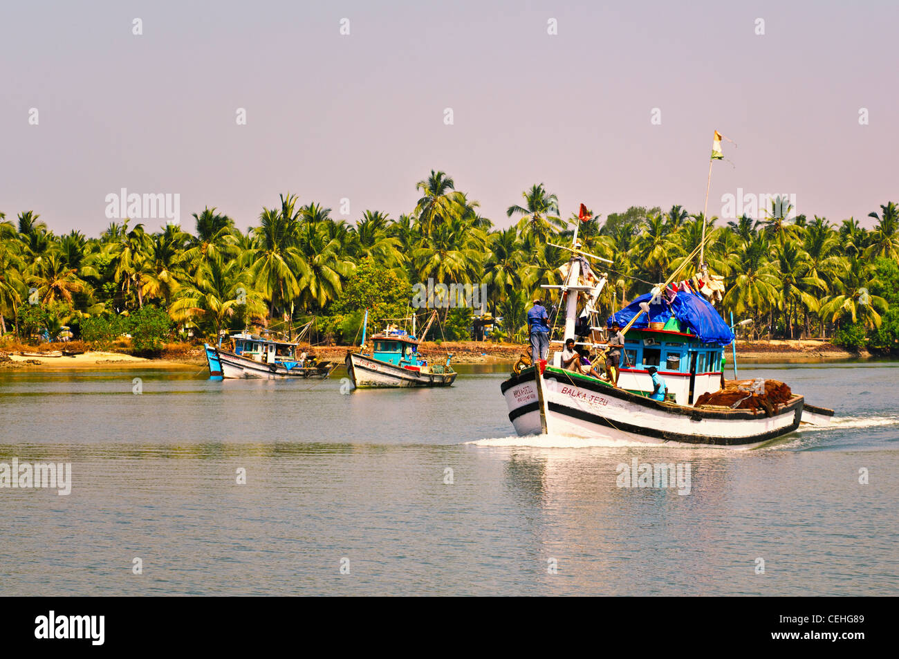 Fishing Trawlers cruising the River Sal in Mobor, South Goa India Stock ...