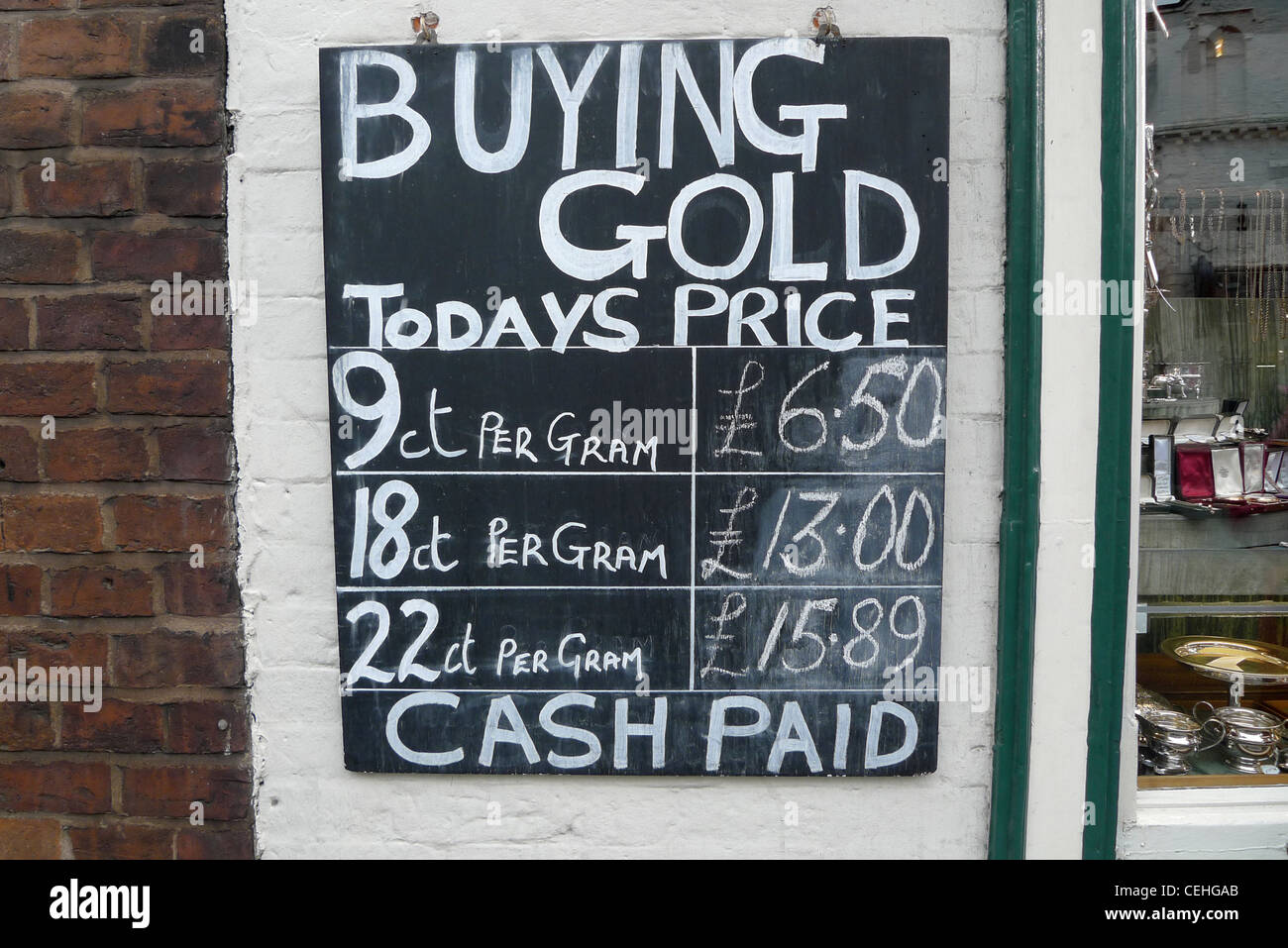 A Buying Gold sign on the exterior of a jewellry shop showing the price ...