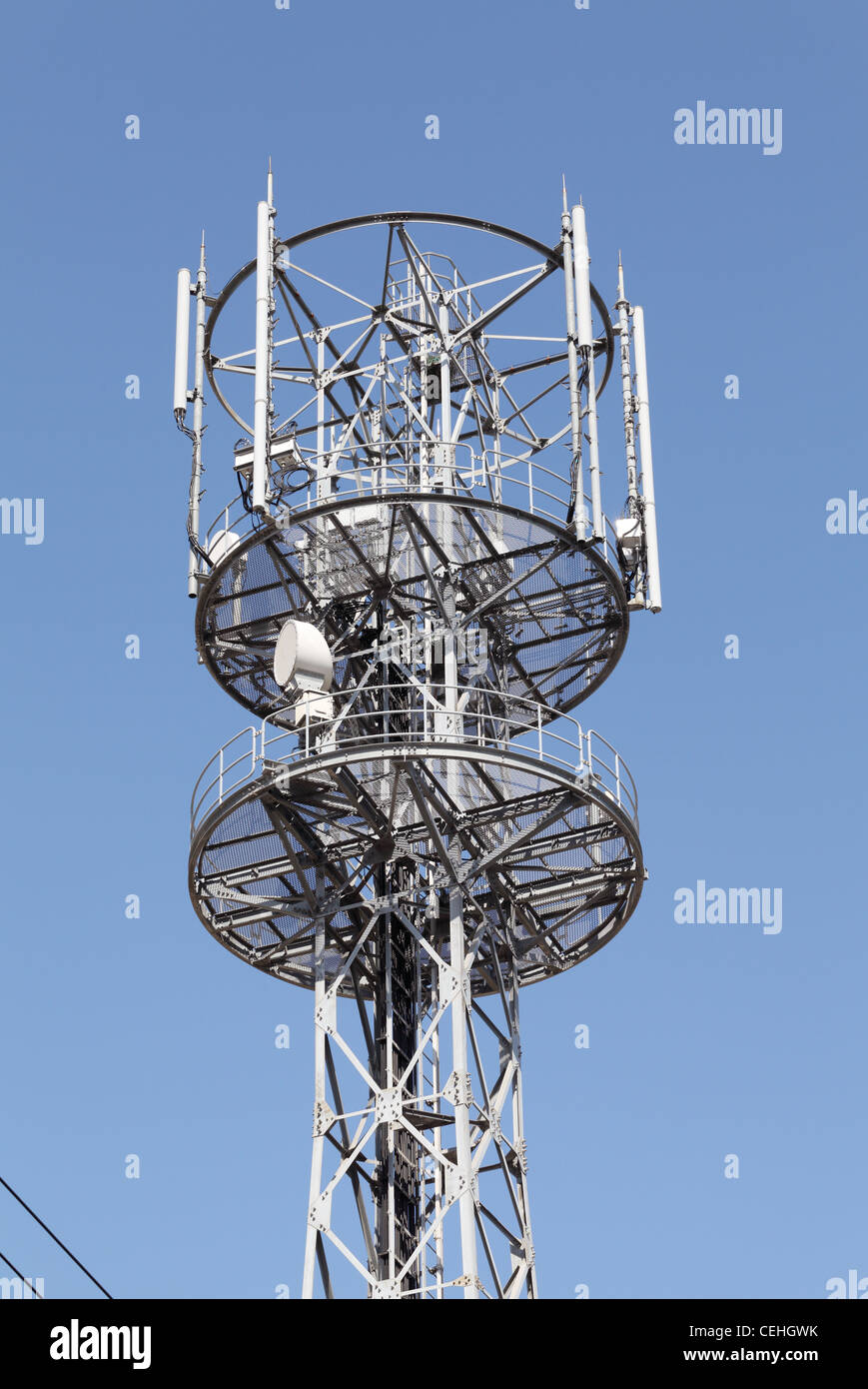 Cell phone tower rises against a blue sky Stock Photo - Alamy