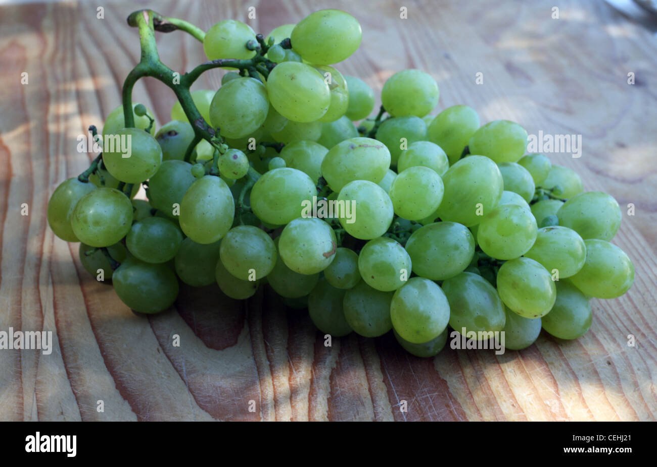 Grapes on a wooden table Stock Photo - Alamy