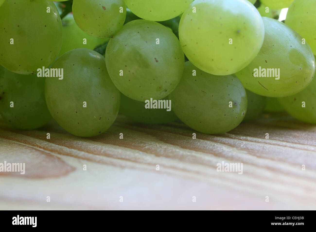 Grapes on a wooden table Stock Photo - Alamy