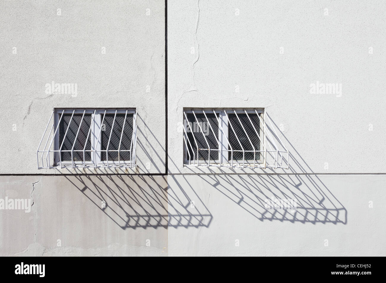 Metal barred or grated security installed on two windows Stock Photo ...
