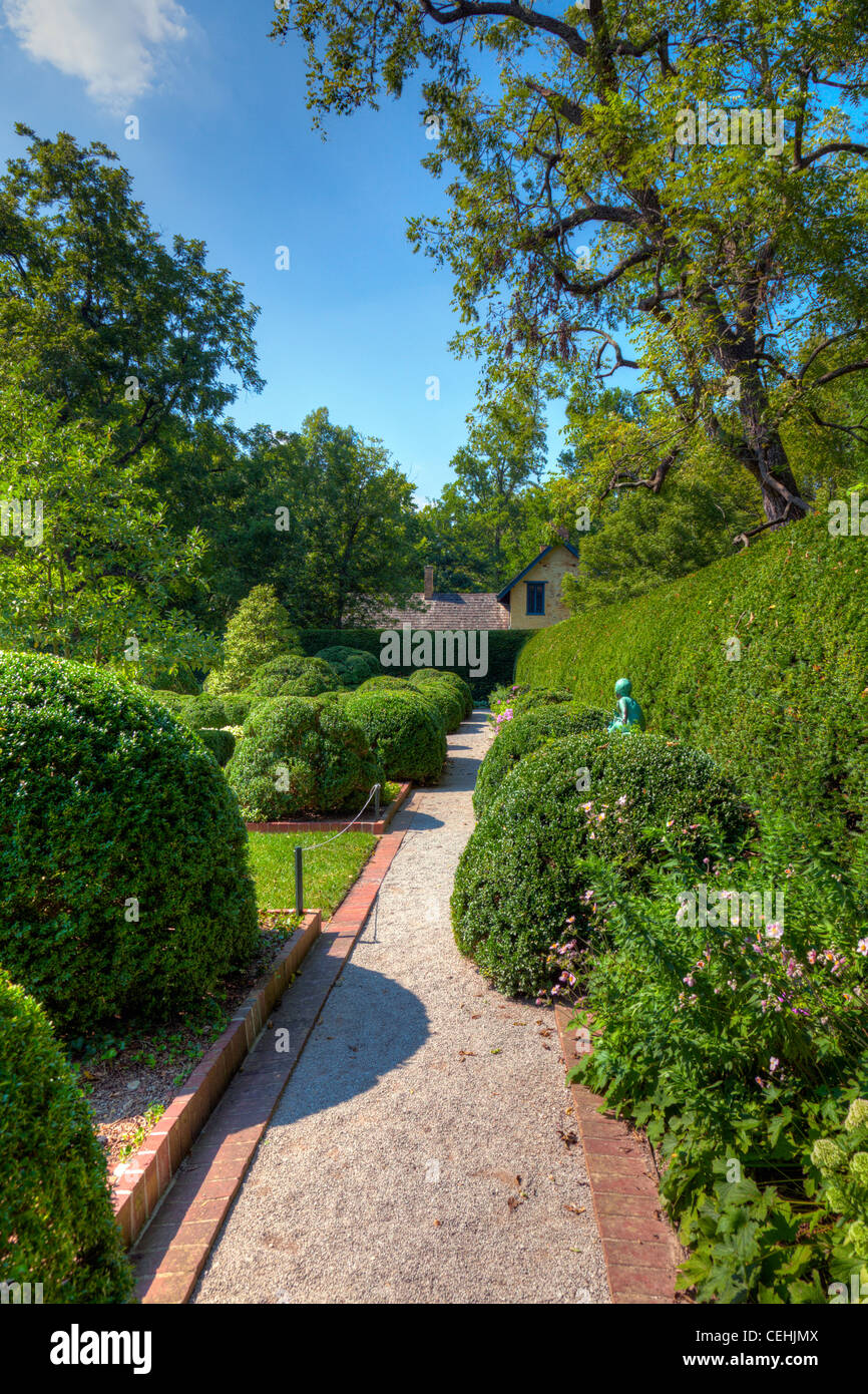 Alley in a garden Stock Photo - Alamy