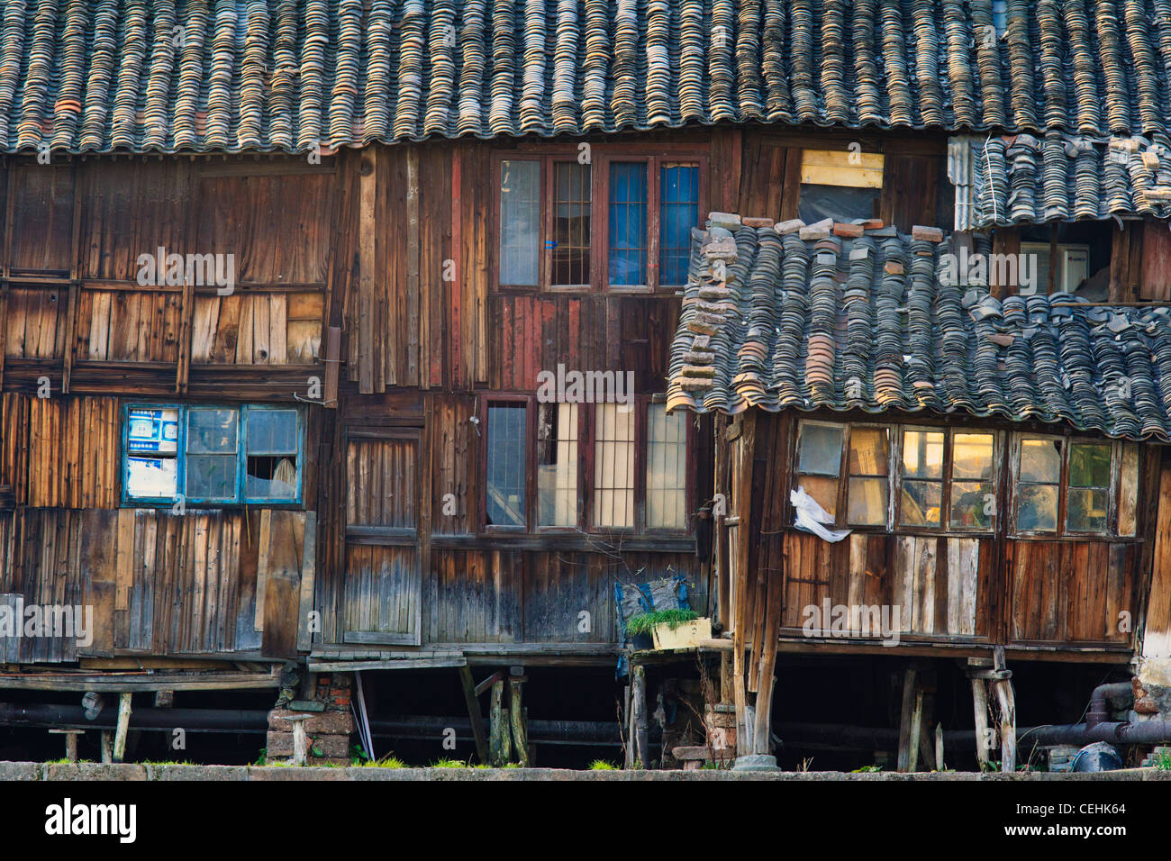 A row of traditional Chinese houses with textured wooden external ...