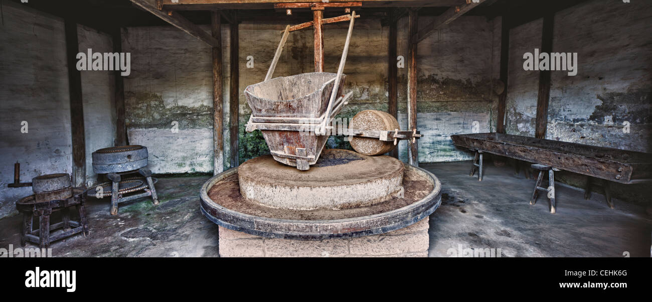A traditional Chinese style millstone grain grinder in the grain ...