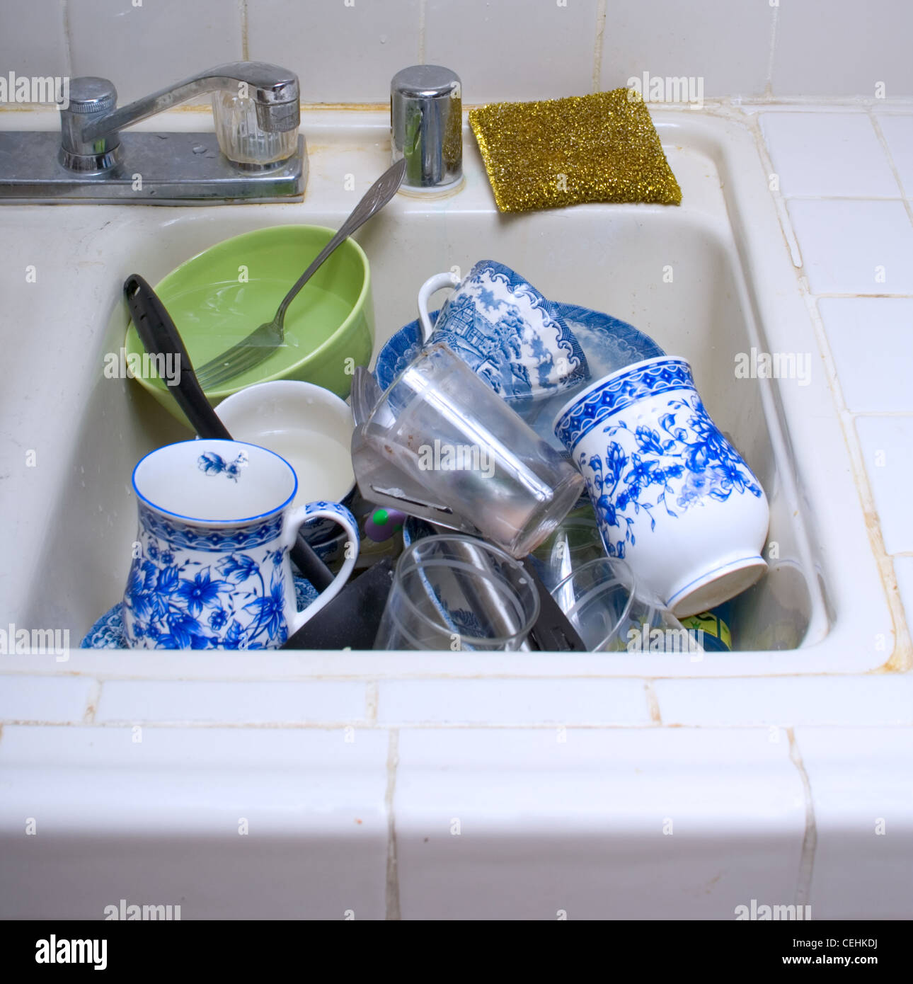 Load of dirty dishes in kitchen sink Stock Photo - Alamy