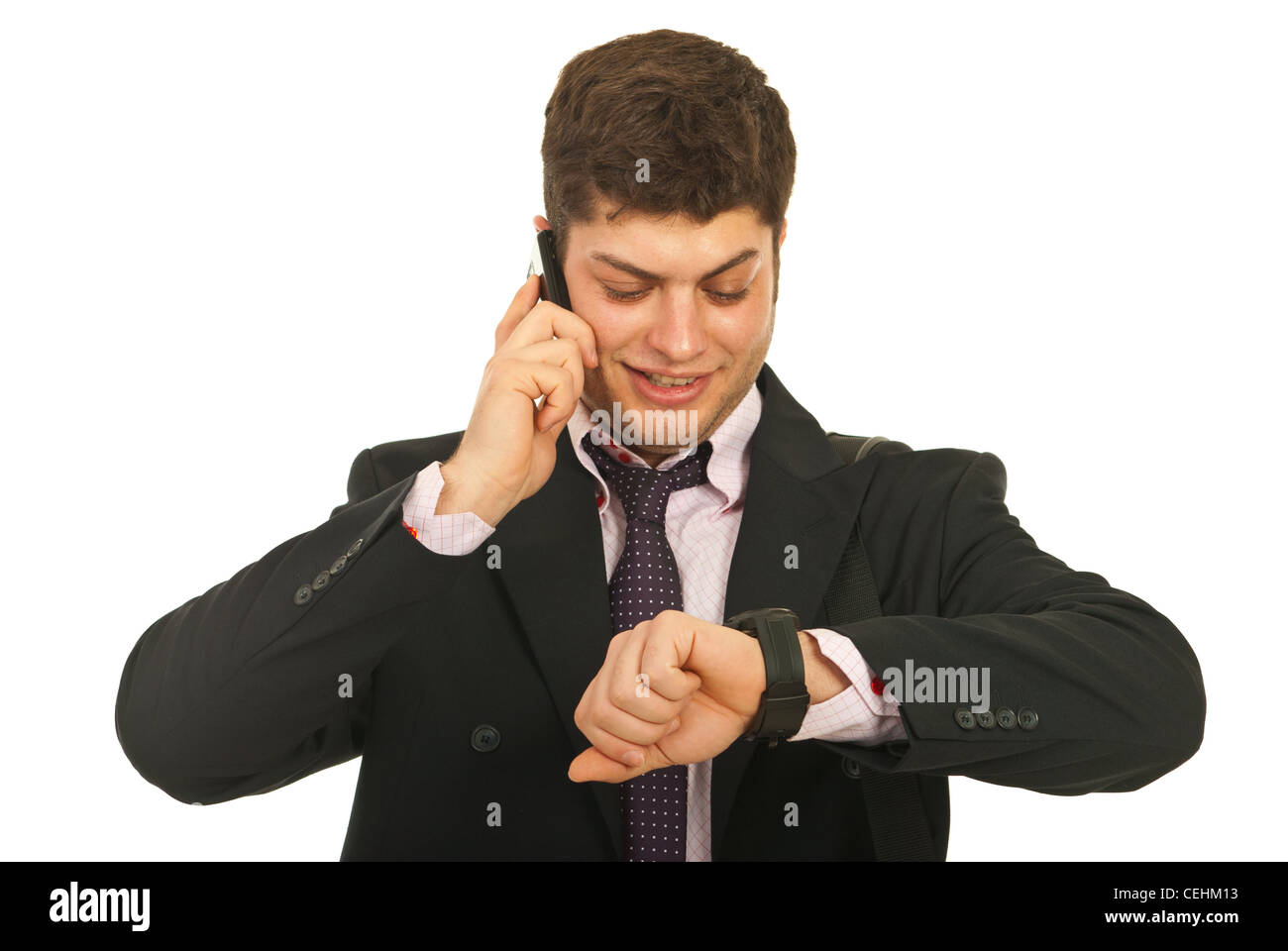 Happy business man speaking by phone mobile and looking at his watch ...