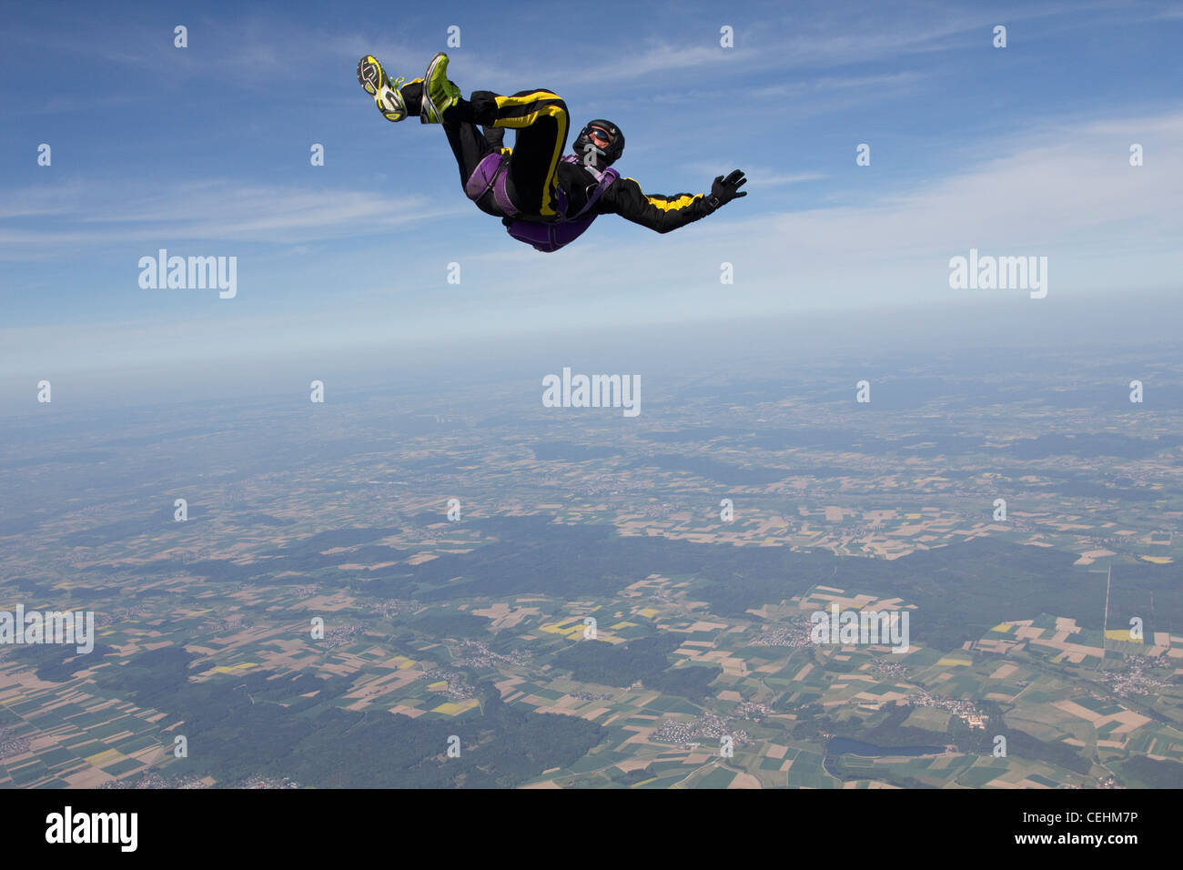 Skydiver is training the back fly position in free fall. He is tracking ...