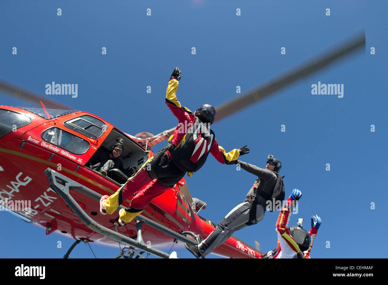 Skydivers are jumping out of a helicopter into freefall. The couple are ...