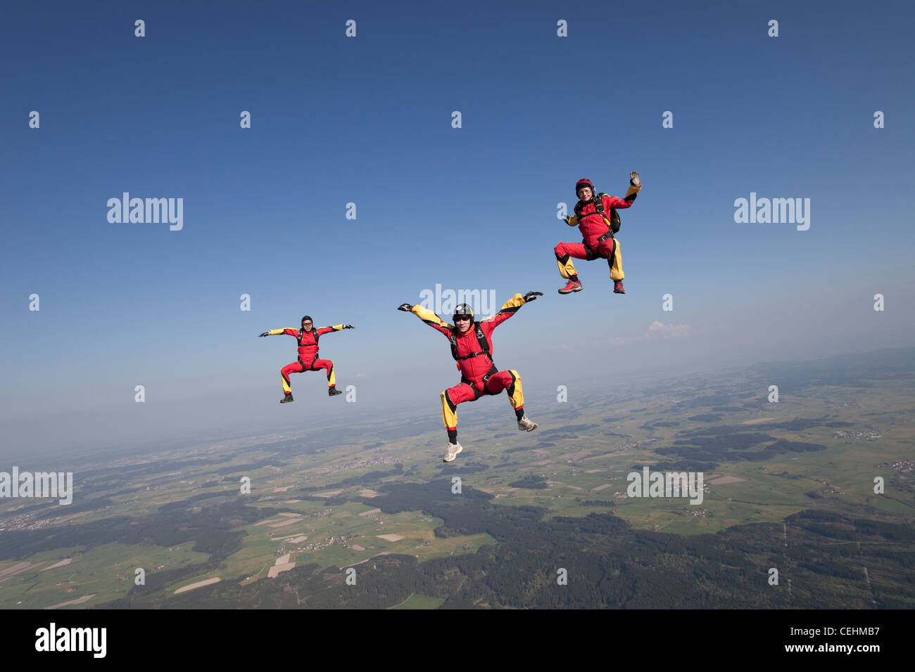 Skydivers are flying head up within a team and try the sit fly position ...