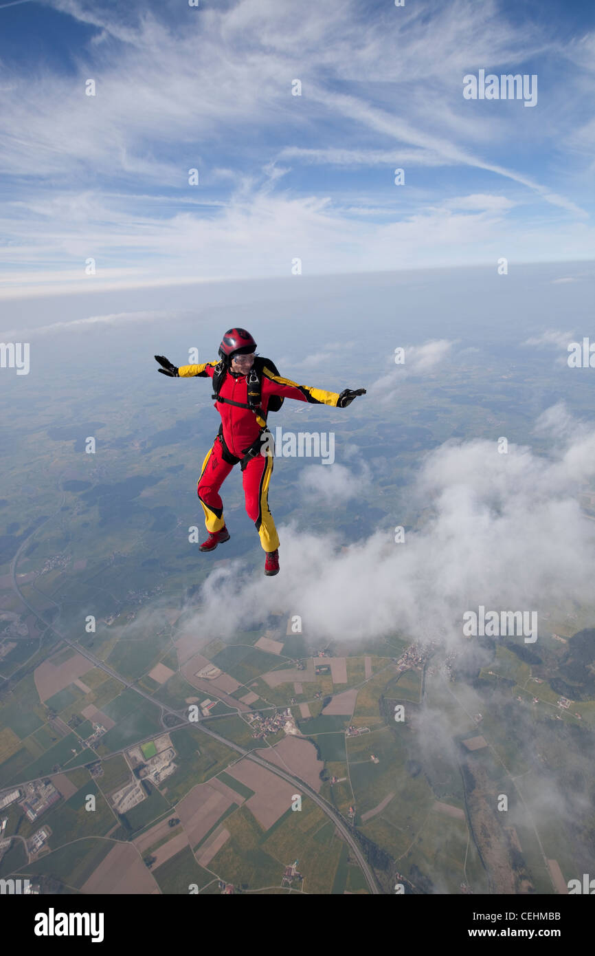 Skydiver is practice the sit position and flying free over a cloud and ...