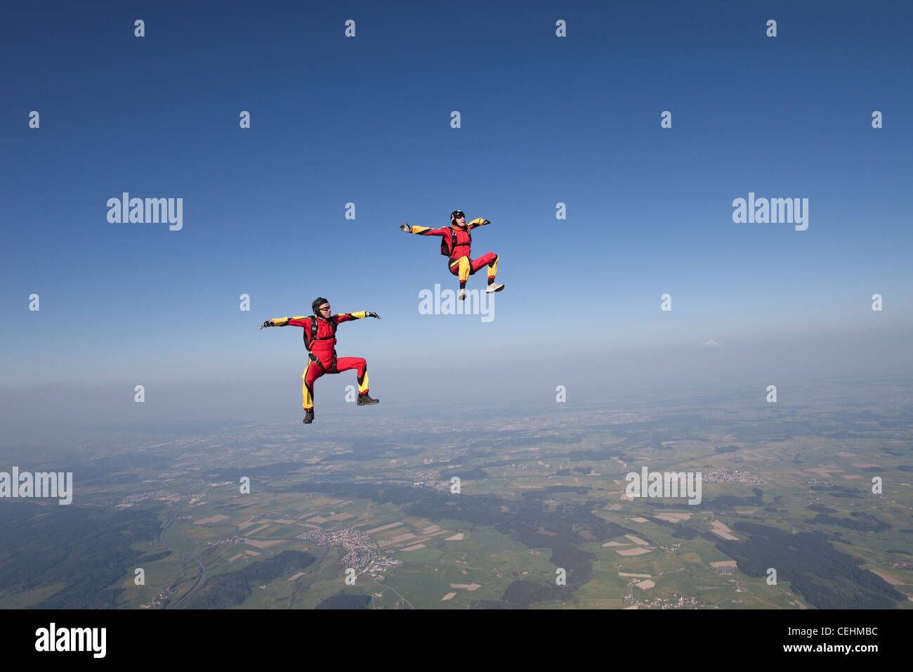 Skydivers are flying head up within a team and try the sit fly position ...