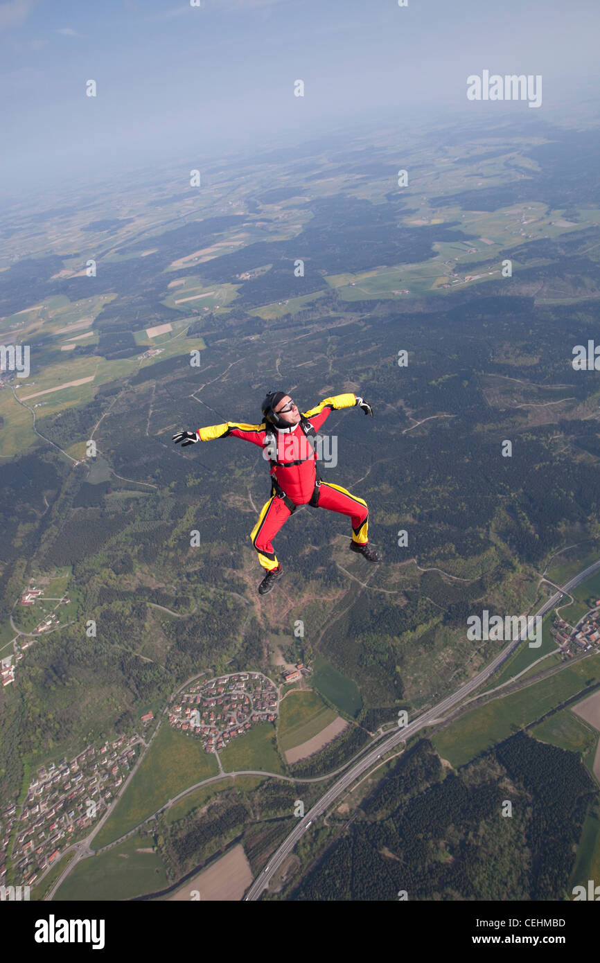 Skydiver is practice the sit position and flying free over nice ...