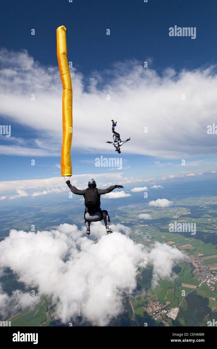 Skydiver with colorful air tube and friends are falling through the ...