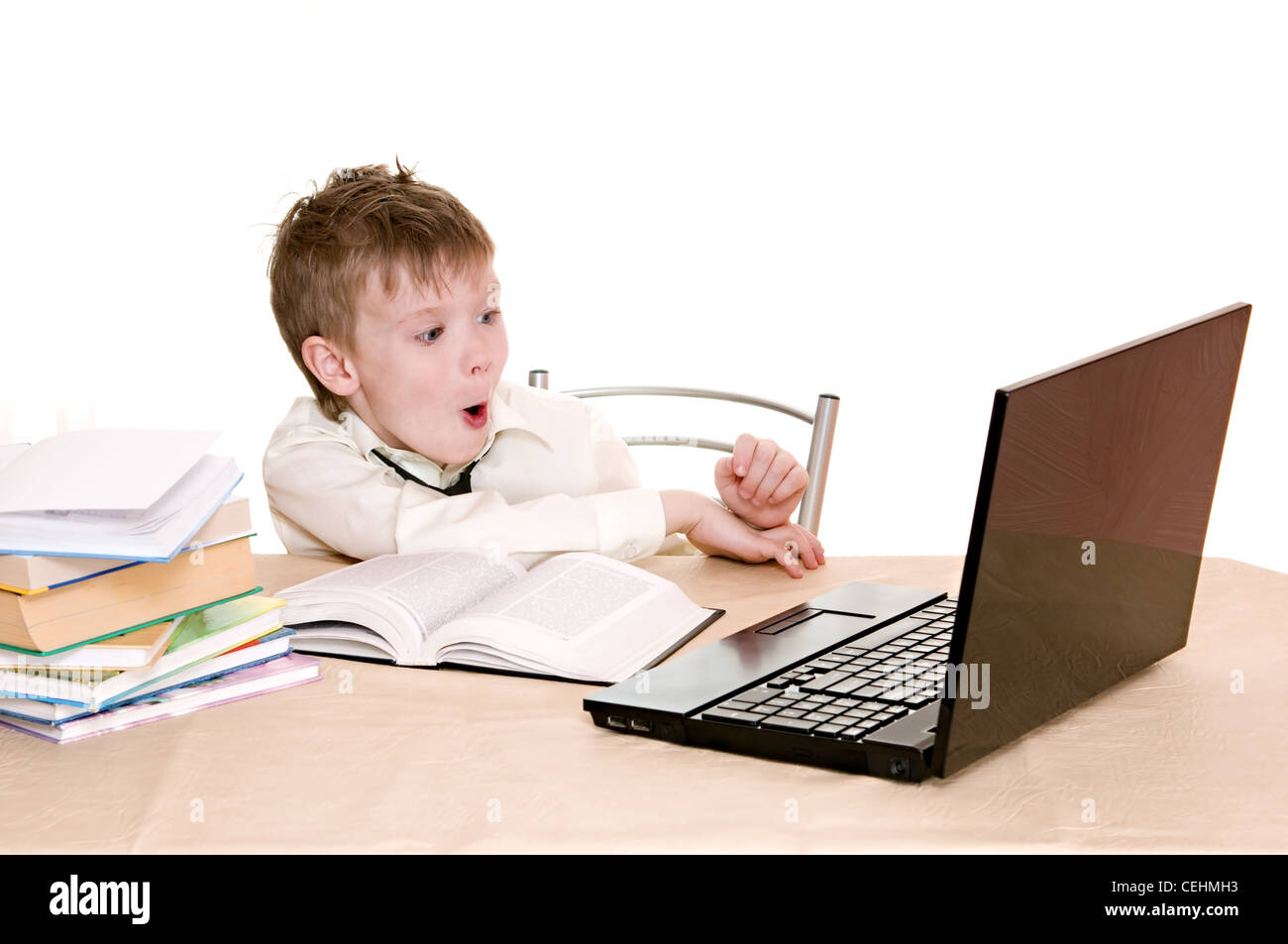 surprised by the boy at the computer isolated on white background Stock ...