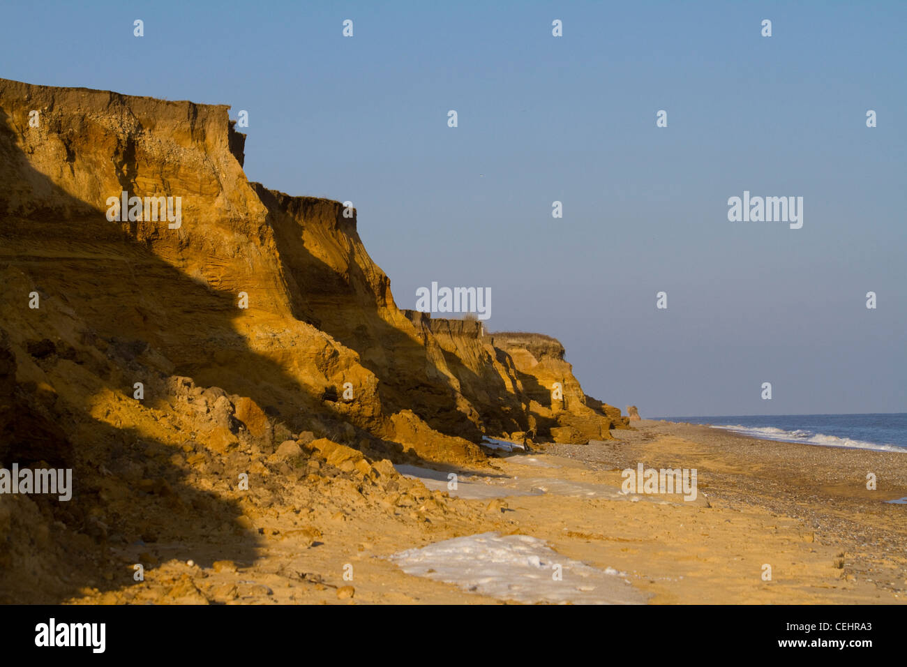 Looking along Benacre beach under the rapidly eroding ochre-coloured ...