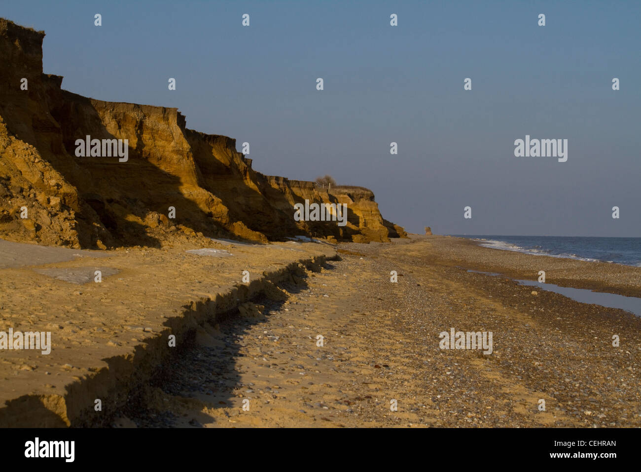 Looking along Benacre beach under the rapidly eroding ochre-coloured ...