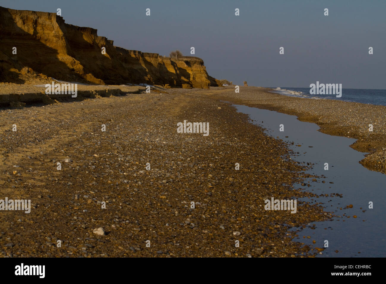 Looking along Benacre beach under the rapidly eroding ochre-coloured ...
