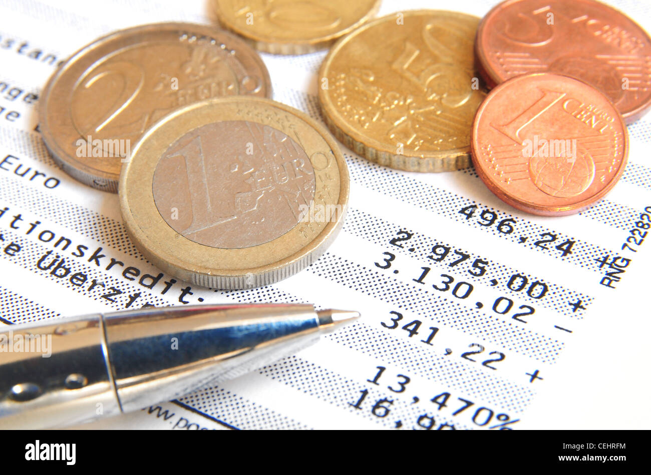 Euro coins and ball pen on top of a bank statement Stock Photo - Alamy