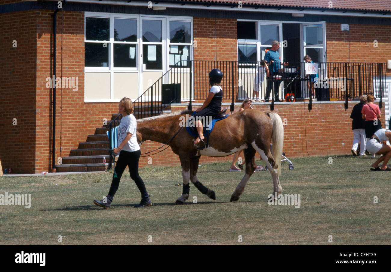 School Fete At A Primary School Girl Riding On A Horse England Stock ...