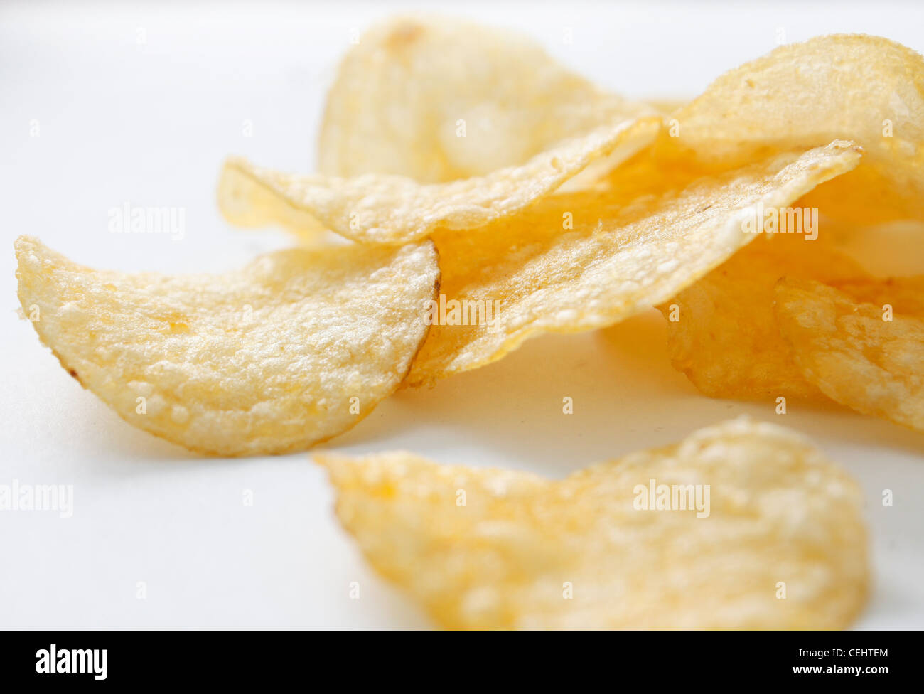 A bunch of potato chips on white Stock Photo - Alamy