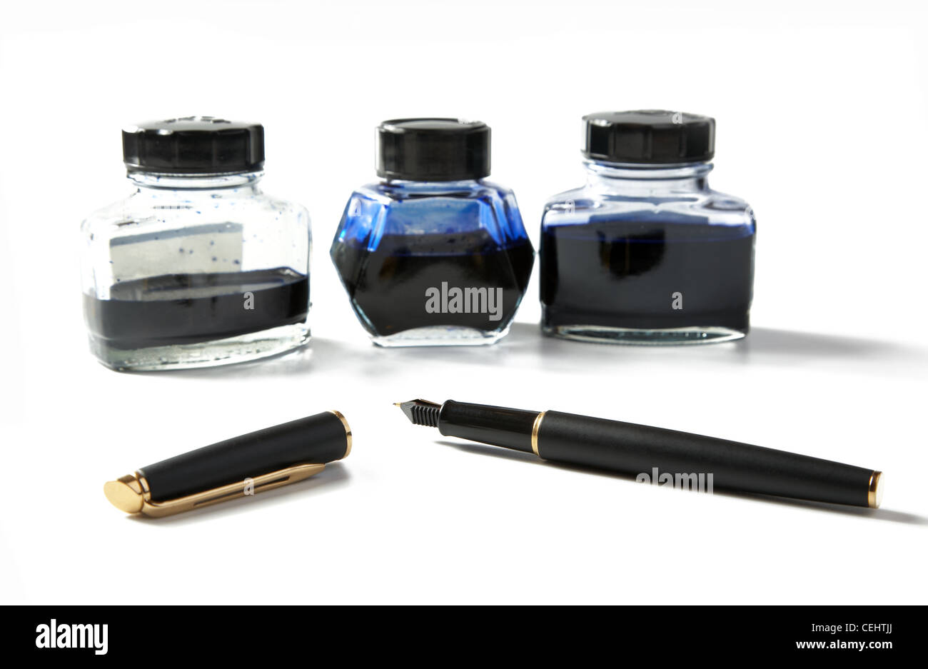 Small bottles with ink and fountain pen on a white background Stock ...