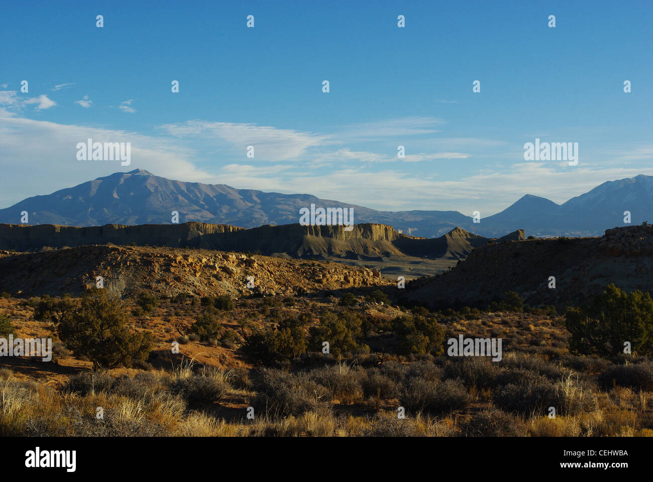 Sandstone and sand formations with Henry Mountains, Utah Stock Photo ...