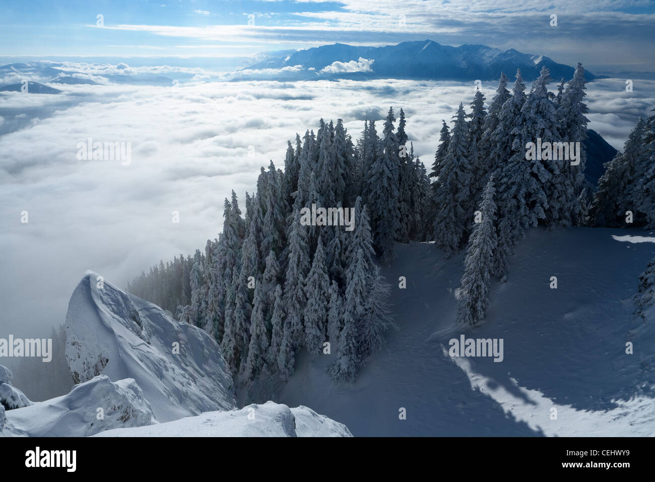 Postavaru mountain rise from a sea of clouds with Bucegi in the ...