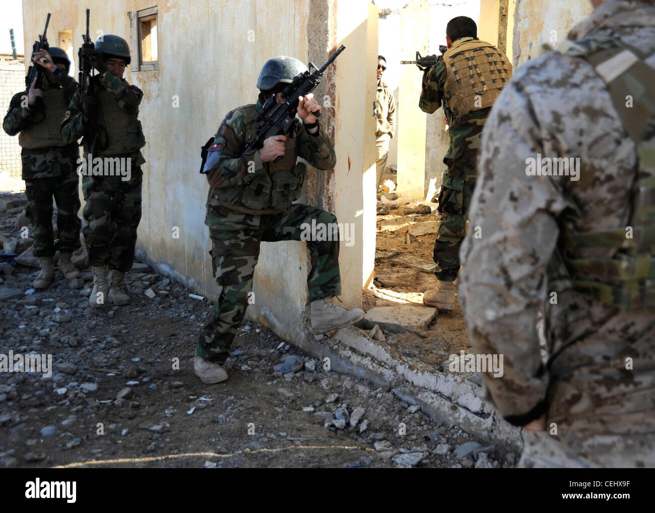 A coalition Special Operations Forces member watches as soldiers from ...