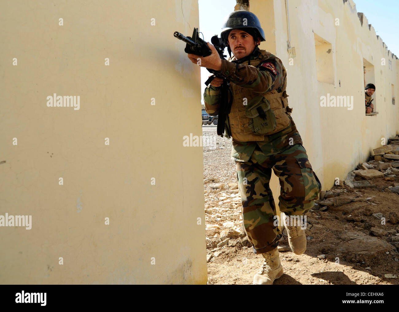 A soldier from the 8th Commando Kandak enters a room while an ...