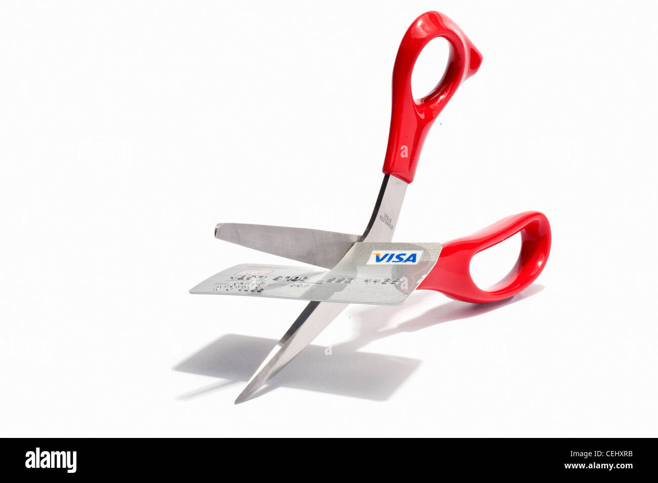 Scissors cutting up a visa credit card Stock Photo - Alamy