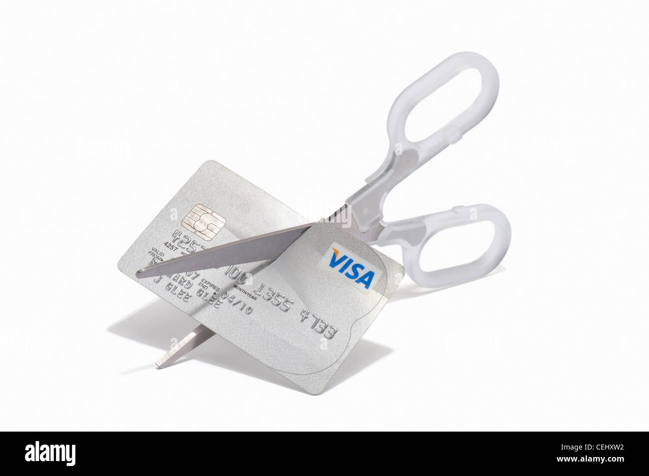Scissors cutting up a visa credit card Stock Photo - Alamy